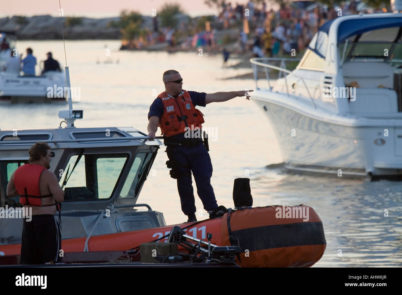 Coast Guard patrol directing boat traffic in harbor Stock Photo - Alamy