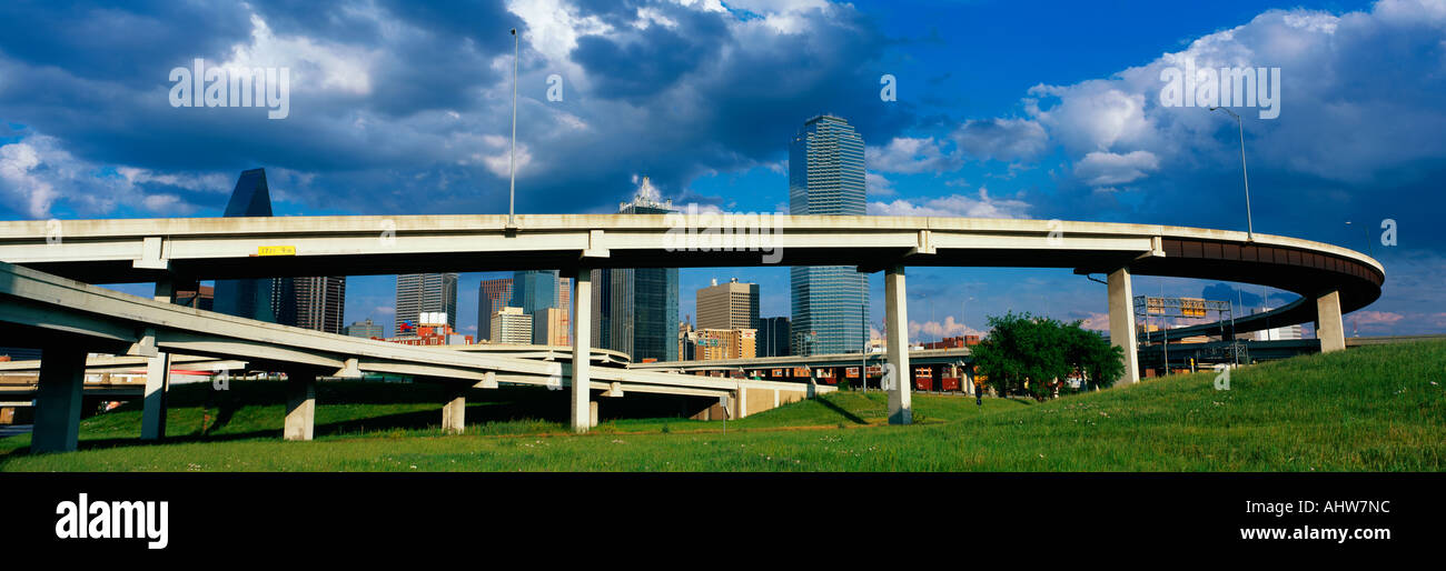 This is a freeway overpass with the Dallas skyline visible behind it ...