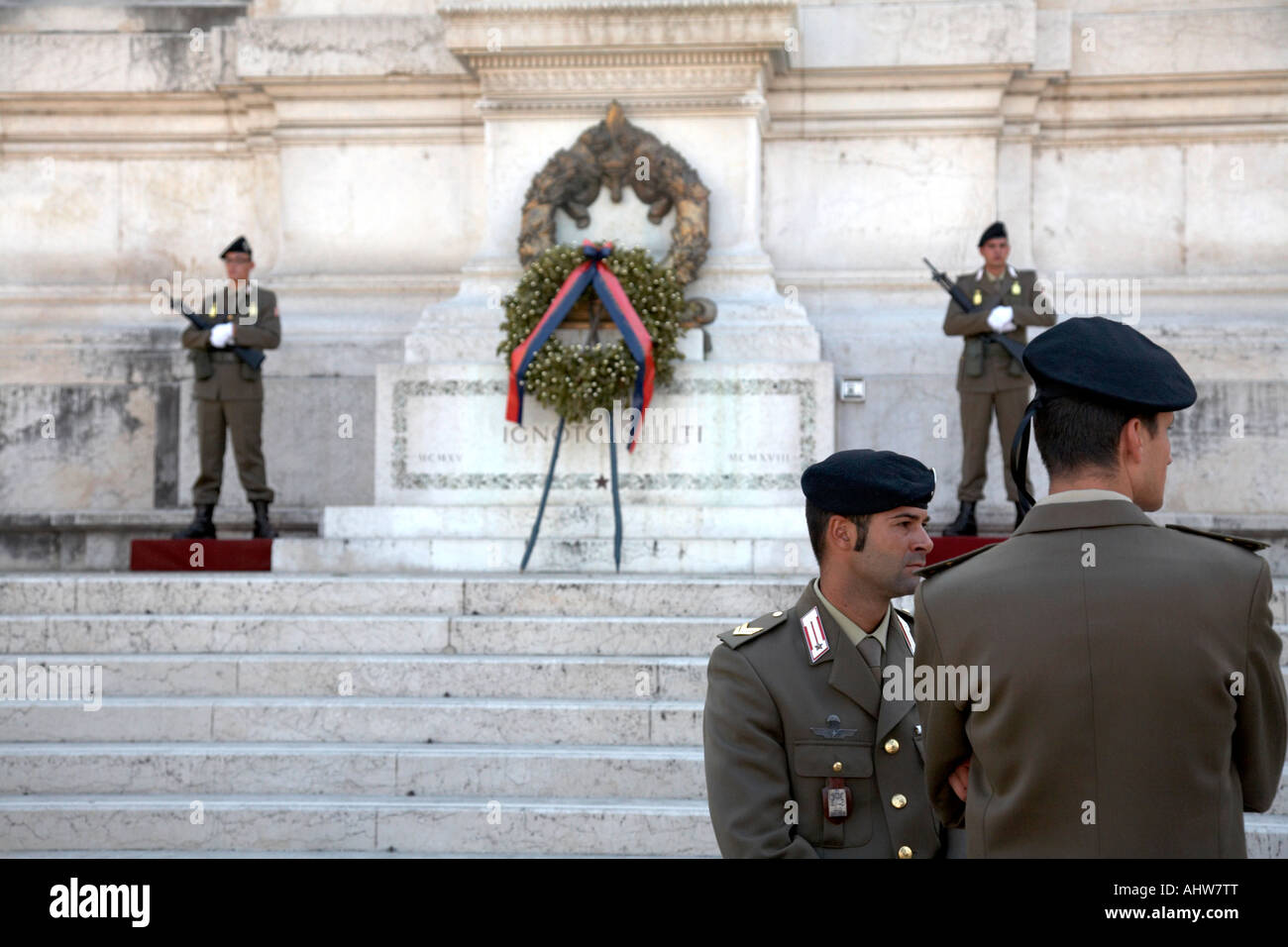 Two Italian army officers guard the wreaths as two other officers watch ...