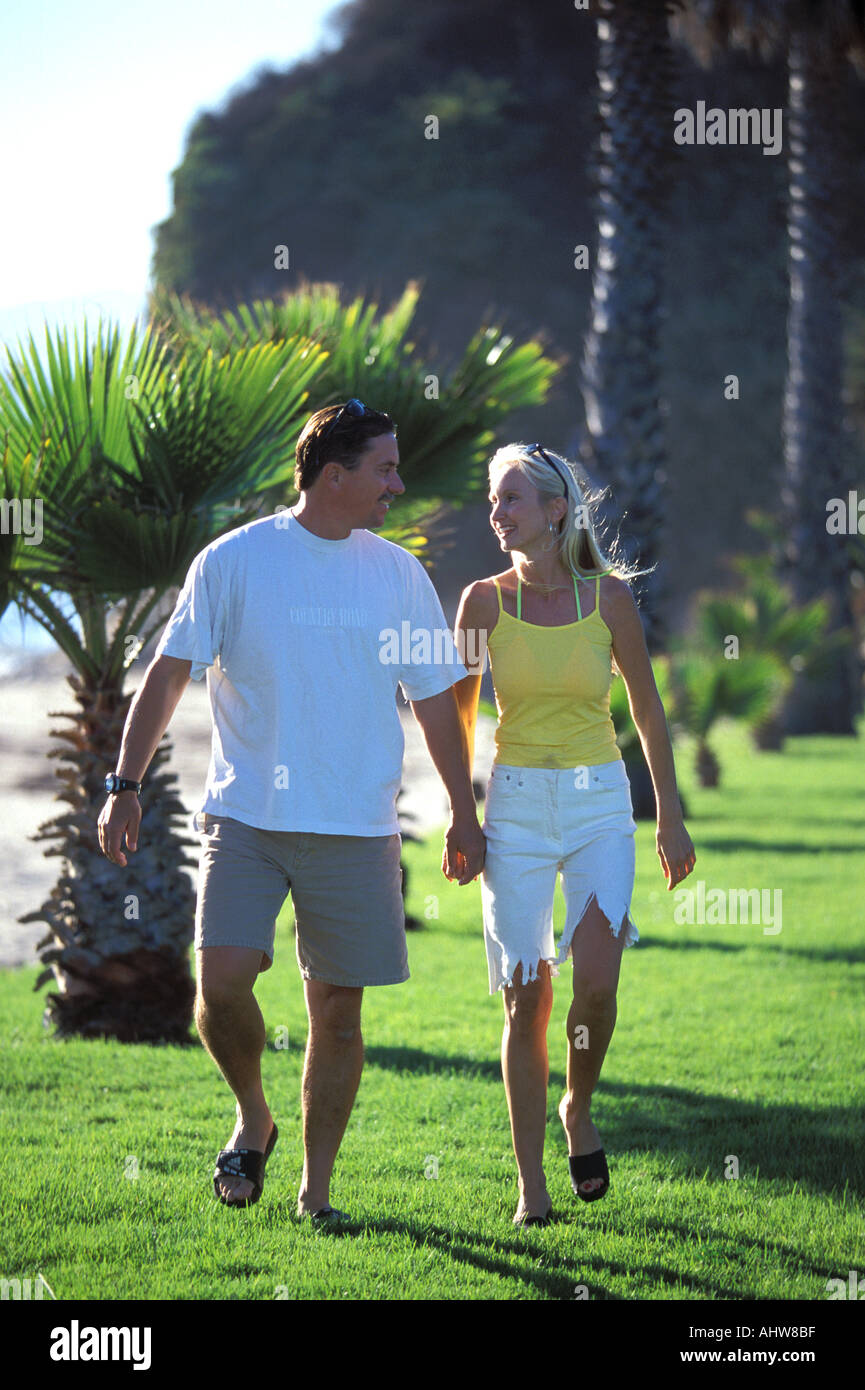 COUPLE WALKING HAND IN HAND Stock Photo - Alamy