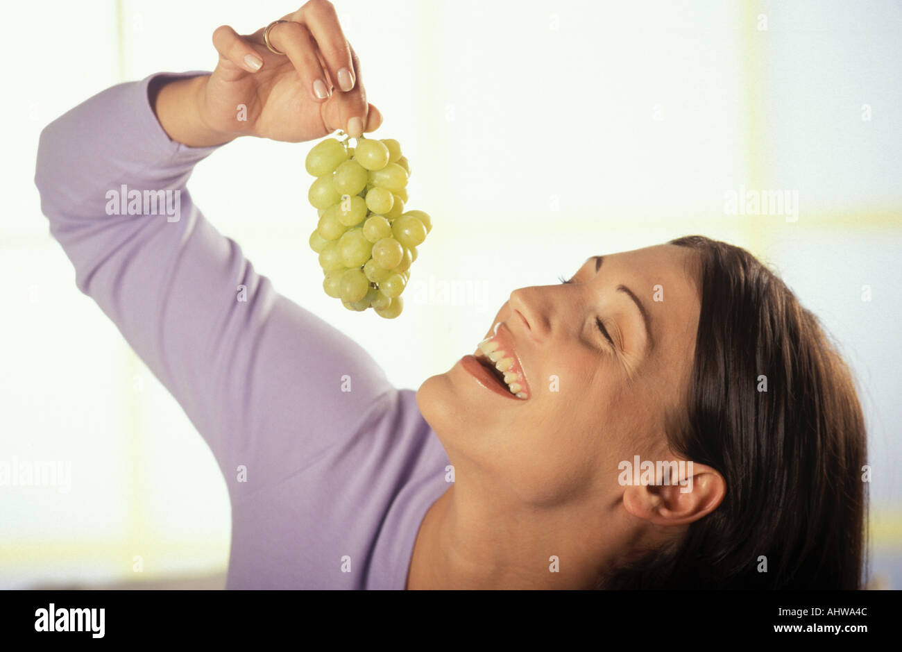 Woman alone eating grapes hi-res stock photography and images - Alamy