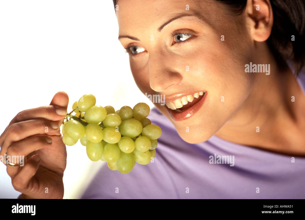 Woman alone eating grapes hi-res stock photography and images - Alamy