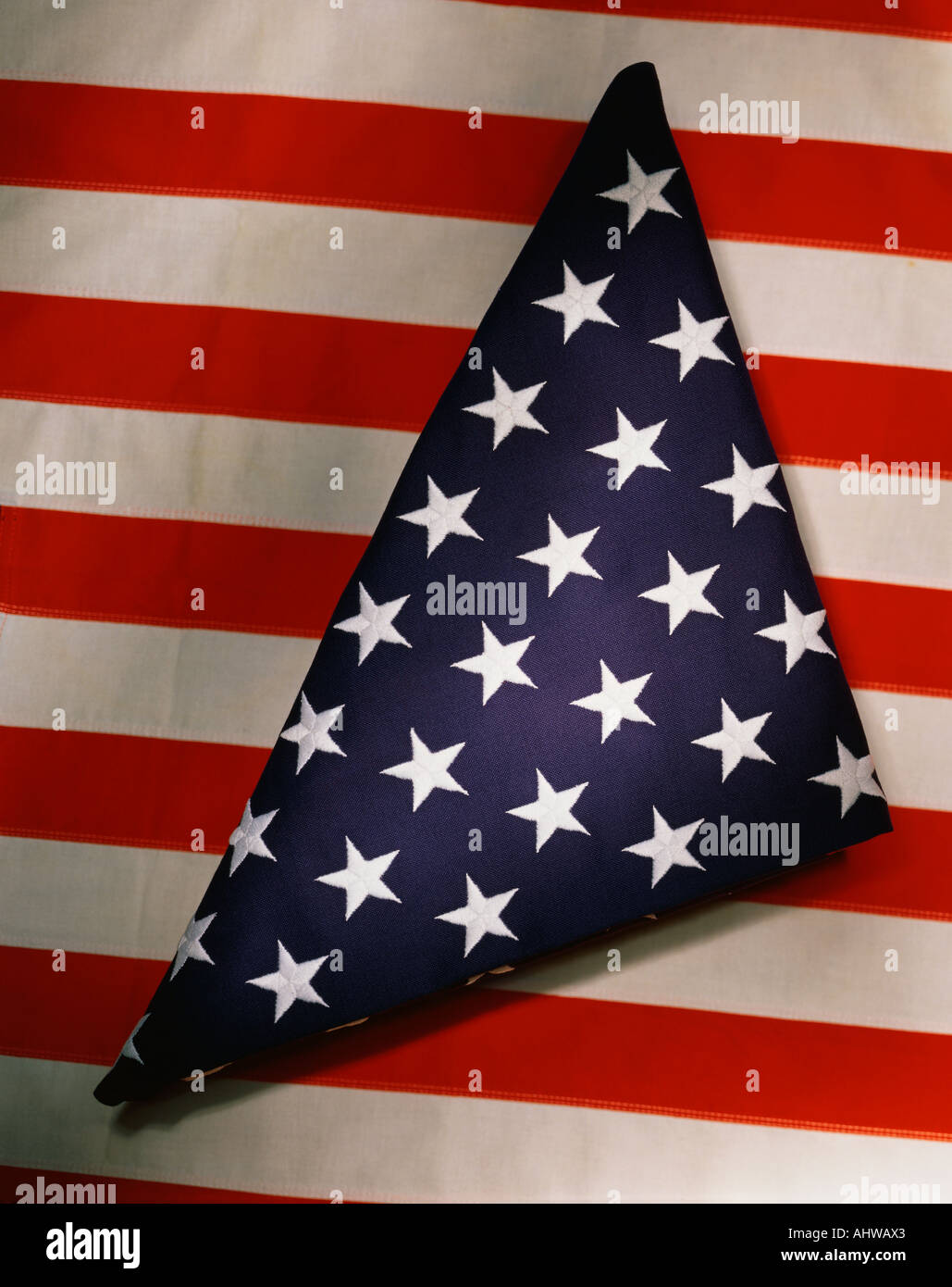 This shows a triangularly folded American flag sitting on top of ...