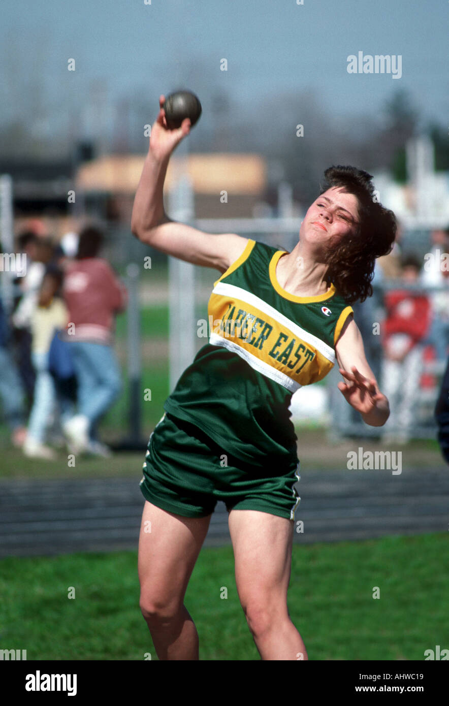 Female participates in the shot put contest at a high school track meet ...