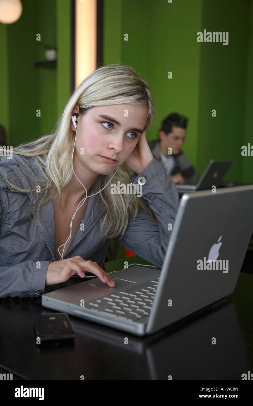 Young people surfing the internet through WLAN at an internet cafe ...