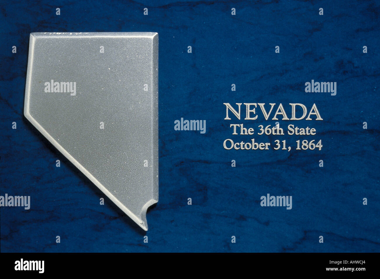 This is a silver map of the state of Nevada against a blue background ...