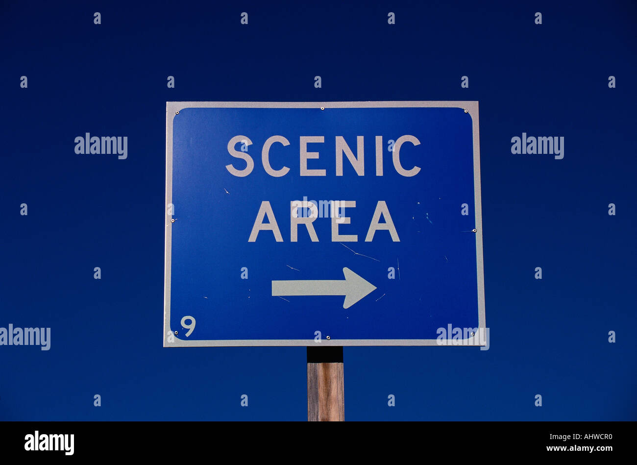 This is a road sign that says Scenic Area with a white arrow pointing ...