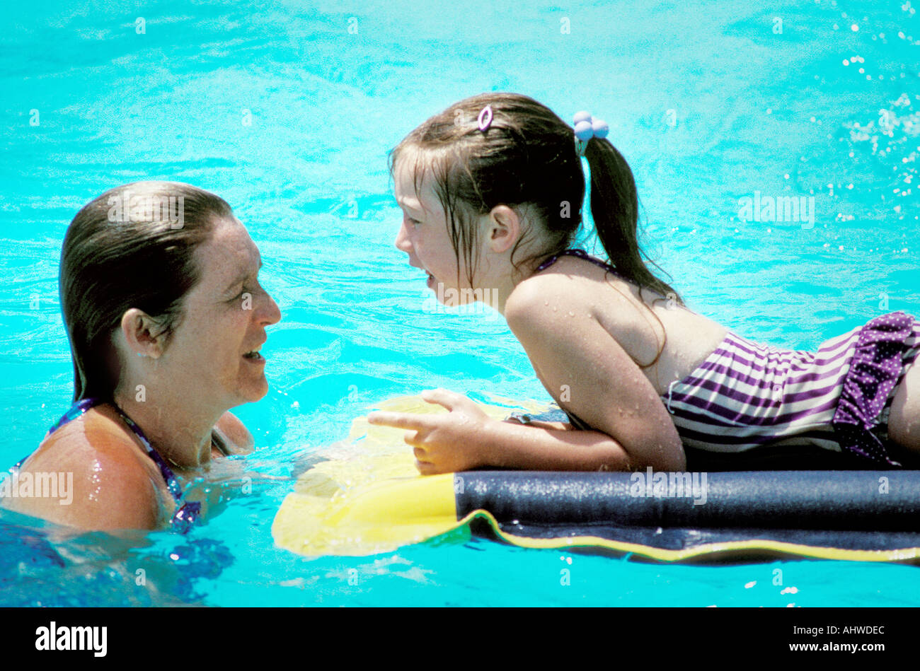 Mother and daughter swim together in a public swimming pool Stock Photo - Alamy