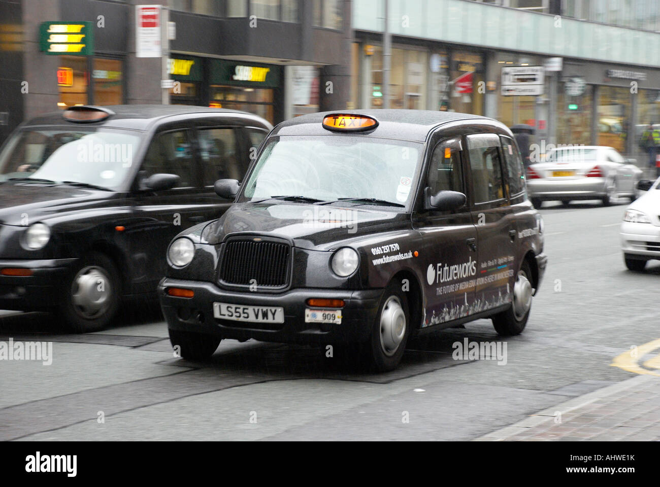 taxi on a manchester city centre street Stock Photo - Alamy