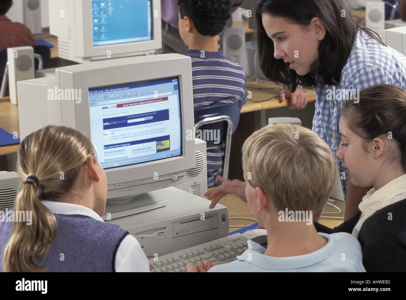 Caucasian students using computer to access internet in middle school ...