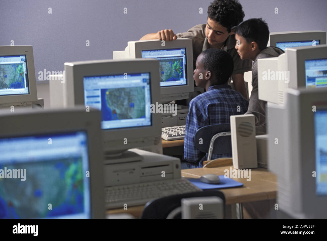 African American Latino Caucasian male students using computer in ...