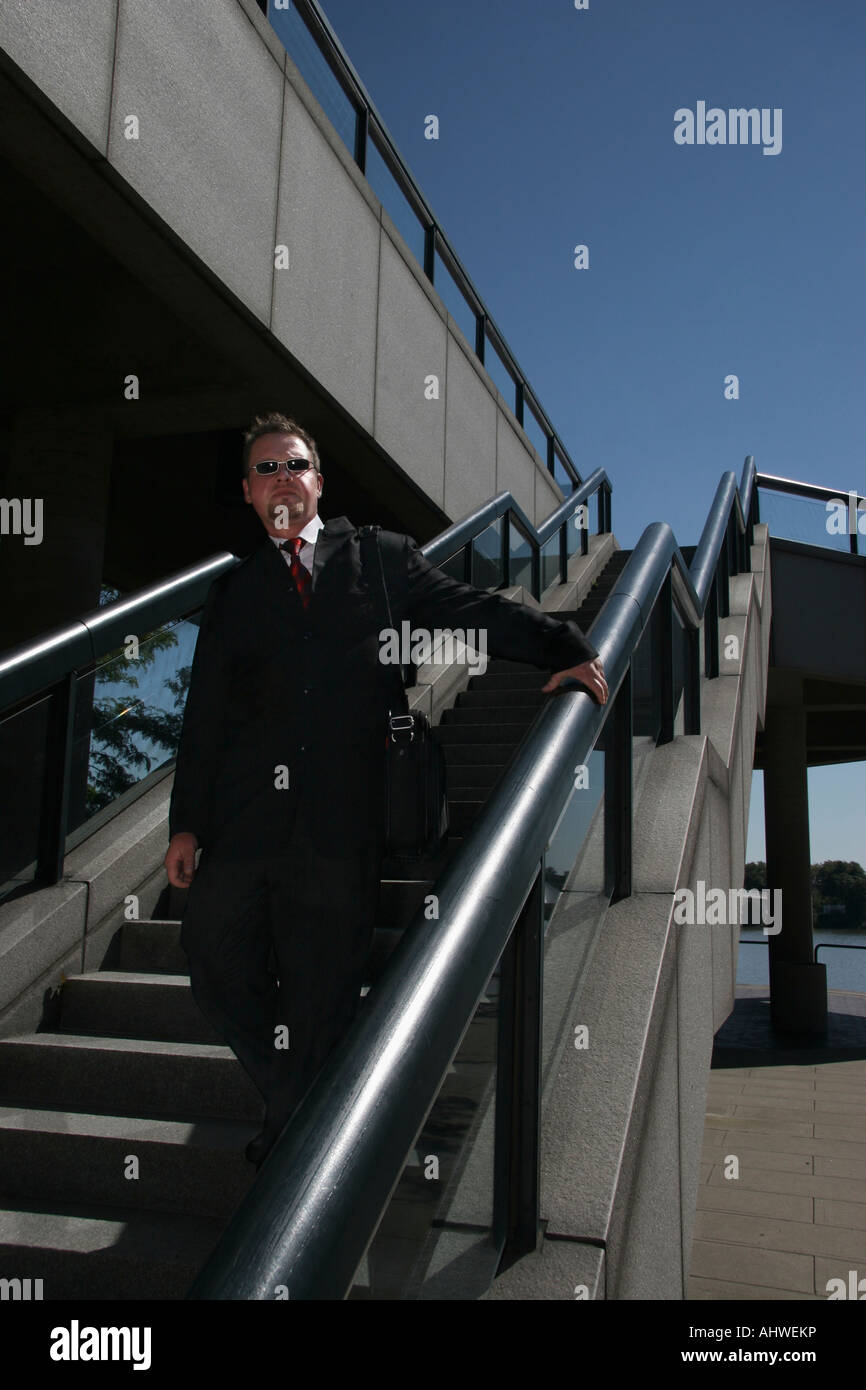 The man manager standing on stairs out of office building on city main ...