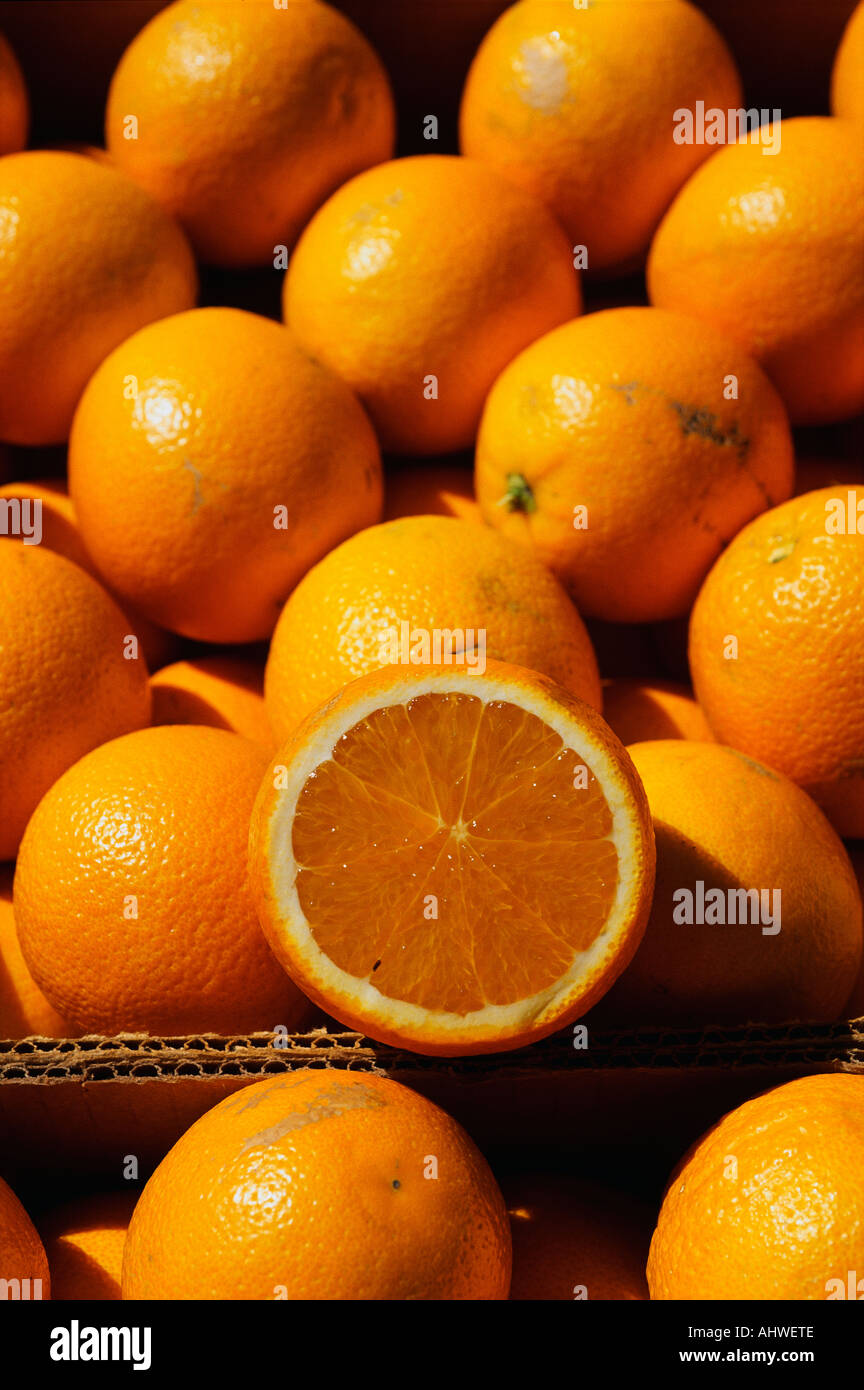 This is a close up of a boxes of oranges One of the oranges has been ...