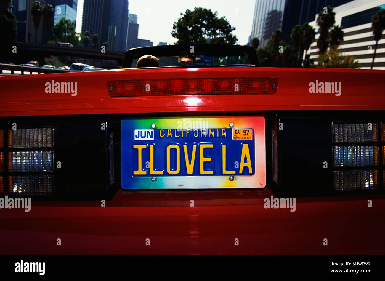 This is a vanity license plate that says I Love LA It is on a red ...