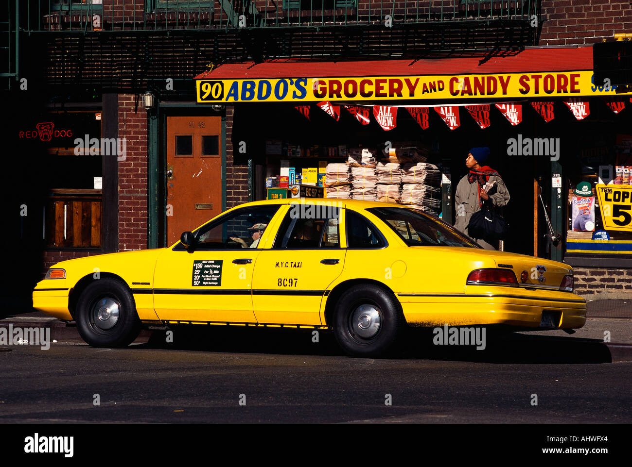 This is a yellow taxi in Greenwich Village parked outside a grocery ...