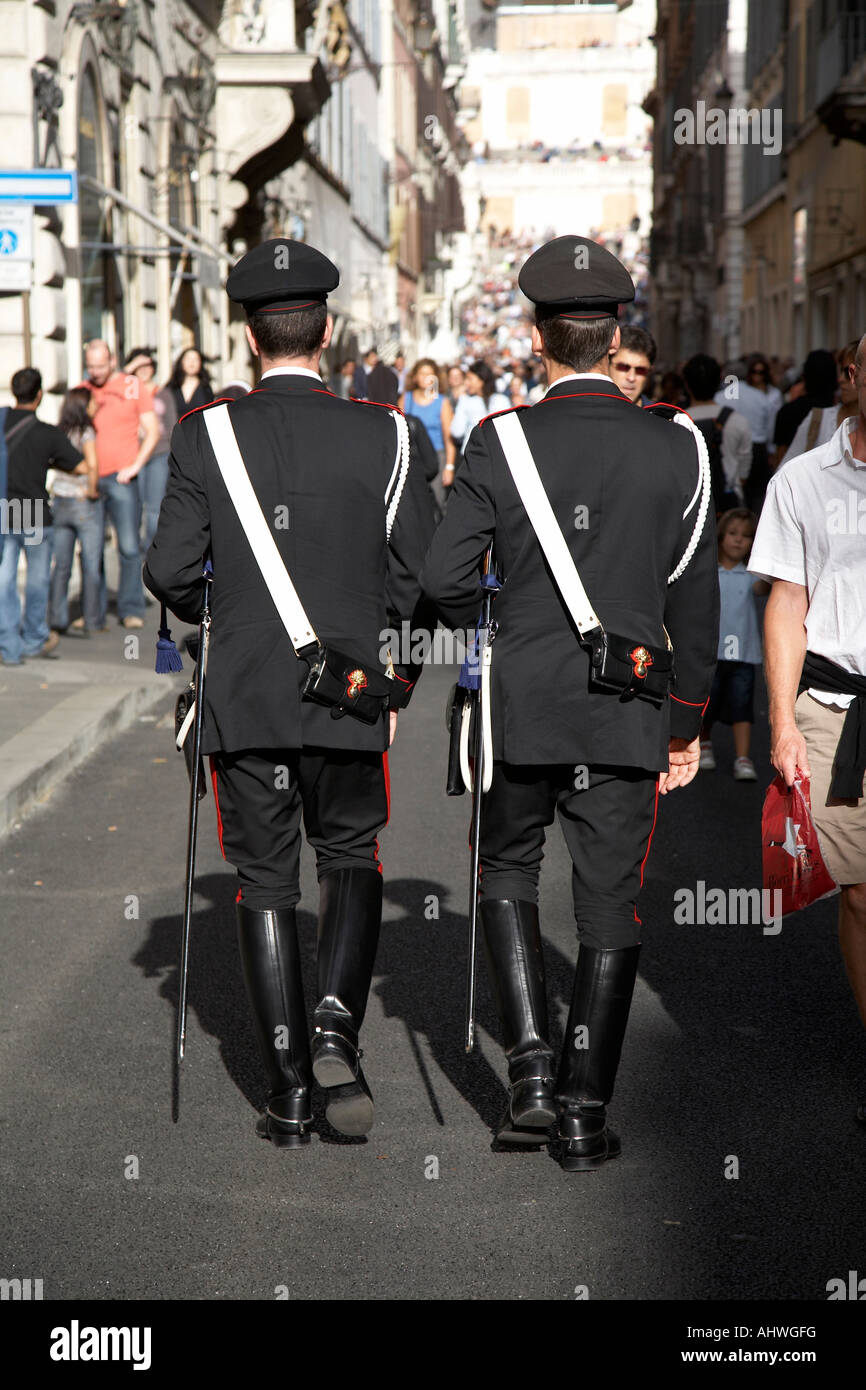 two italian police officers with ceremonial swords go along Via ...