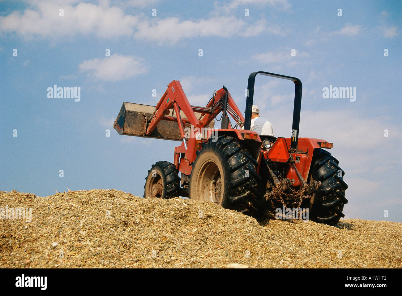 Tractor riding up hill Stock Photo - Alamy