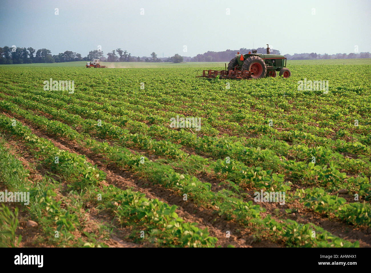 Tractors out in field Stock Photo - Alamy