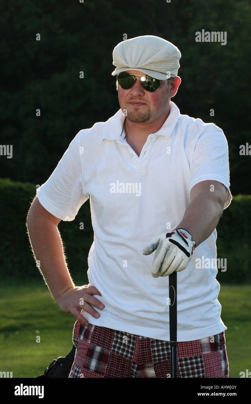 American golf player with golf club portrait of a caucasian young man ...