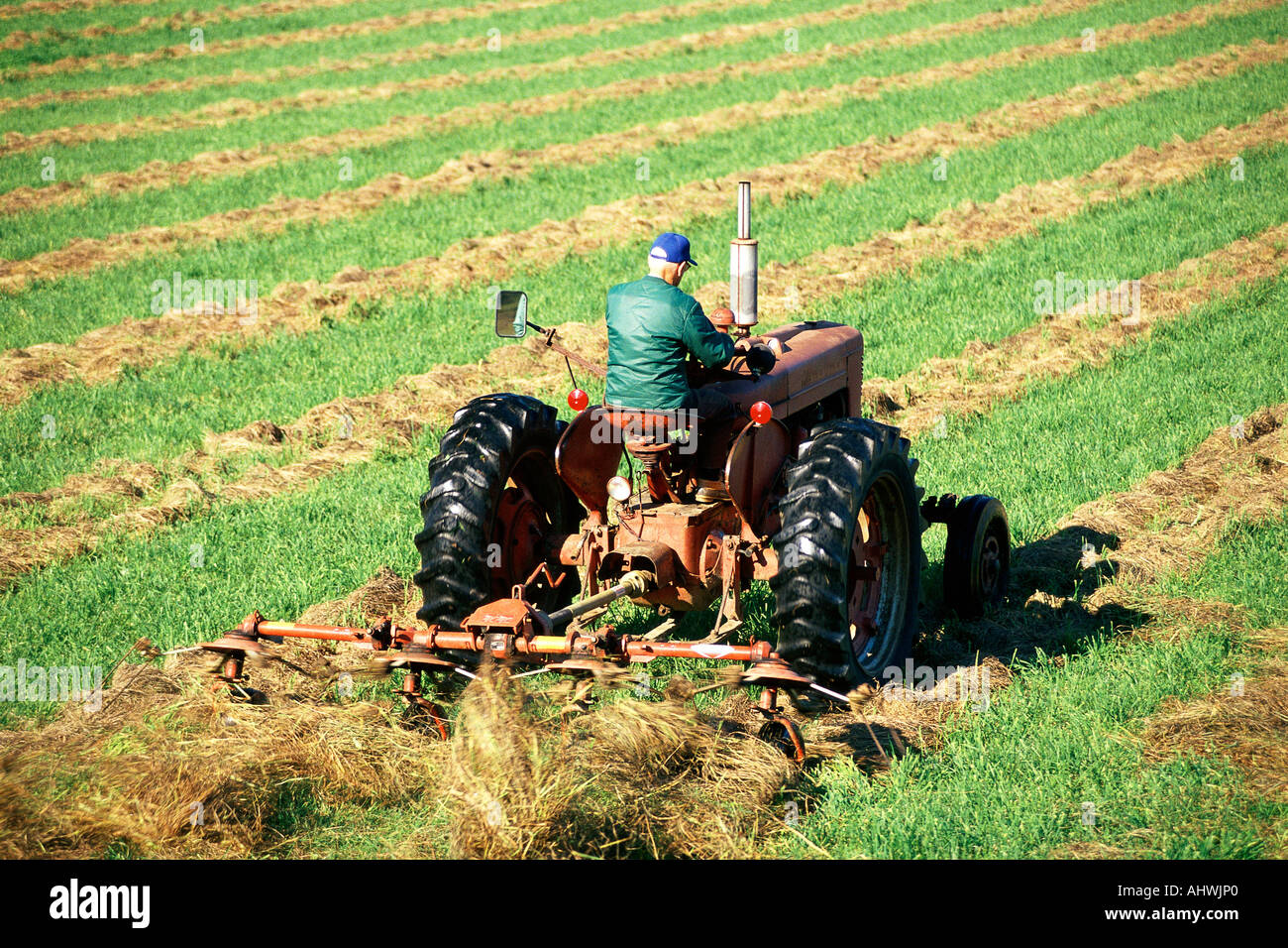 Farmer on tractor in field Stock Photo - Alamy