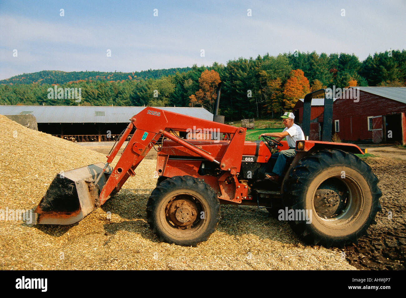 Side shot of farmer on combine harvester Stock Photo - Alamy