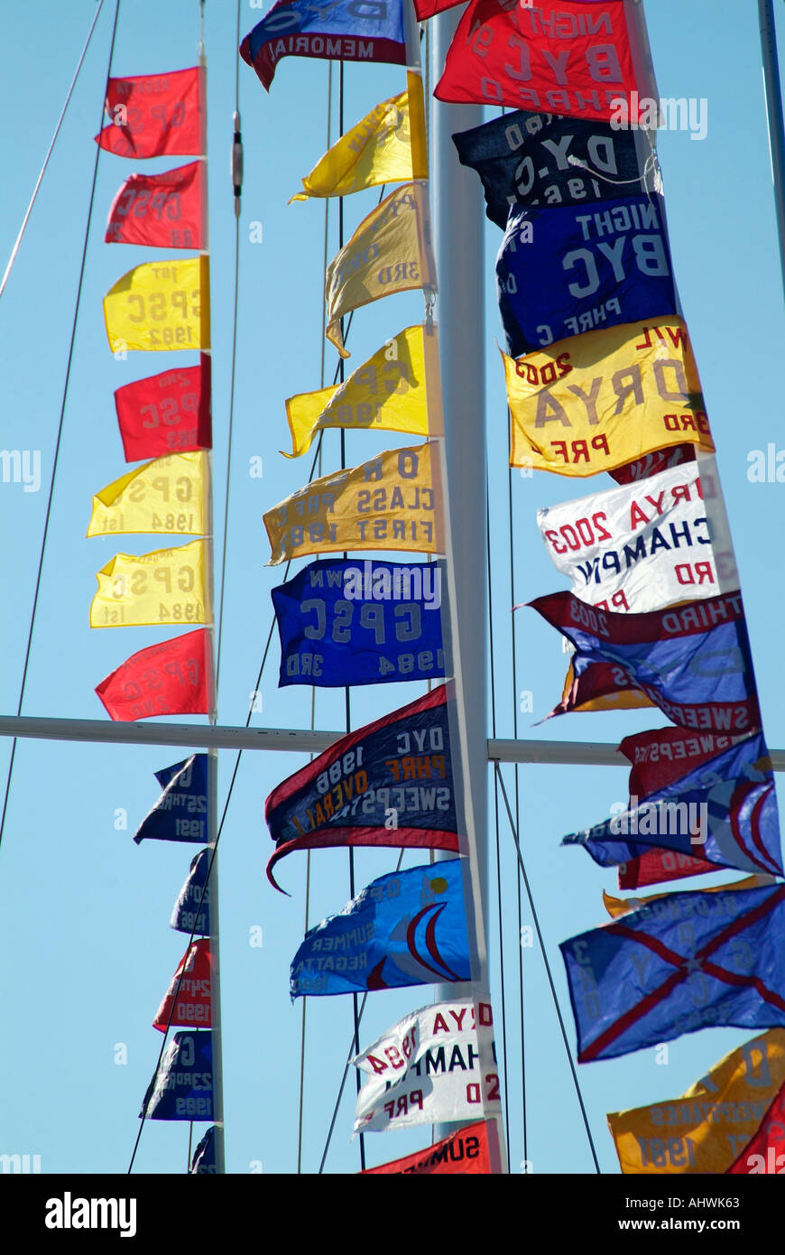 Flags from various yacht clubs are stung on the lines of sailboats ...