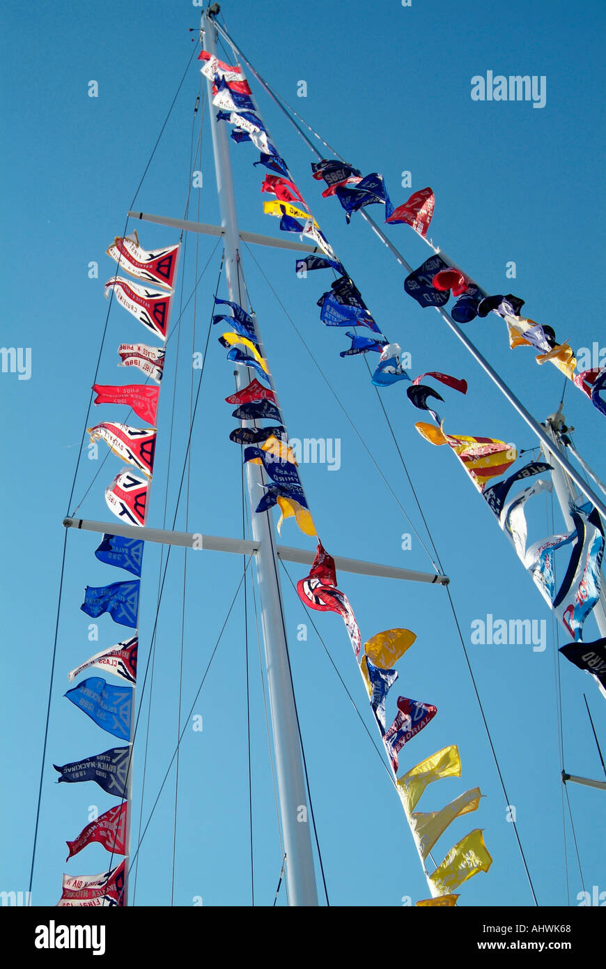Flags from various yacht clubs are stung on the lines of sailboats ...