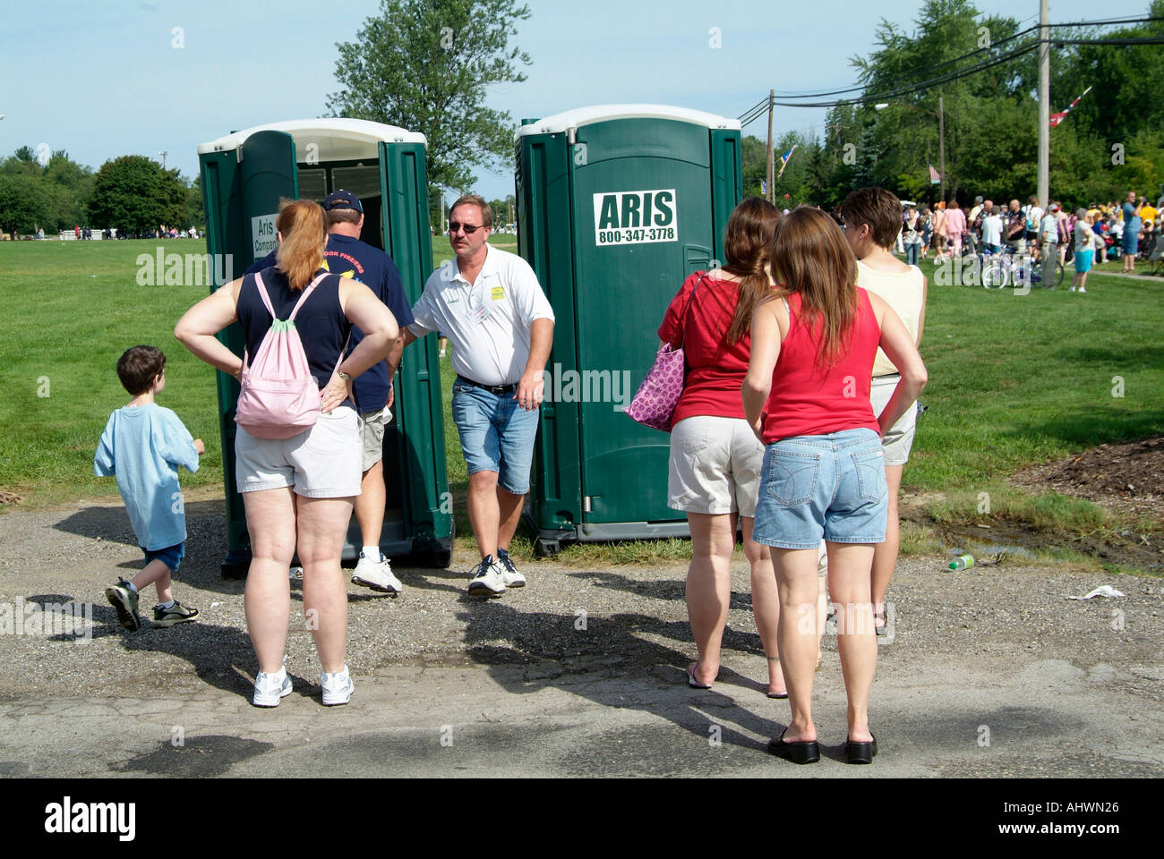 People line up to use a public portable toilet Stock Photo - Alamy