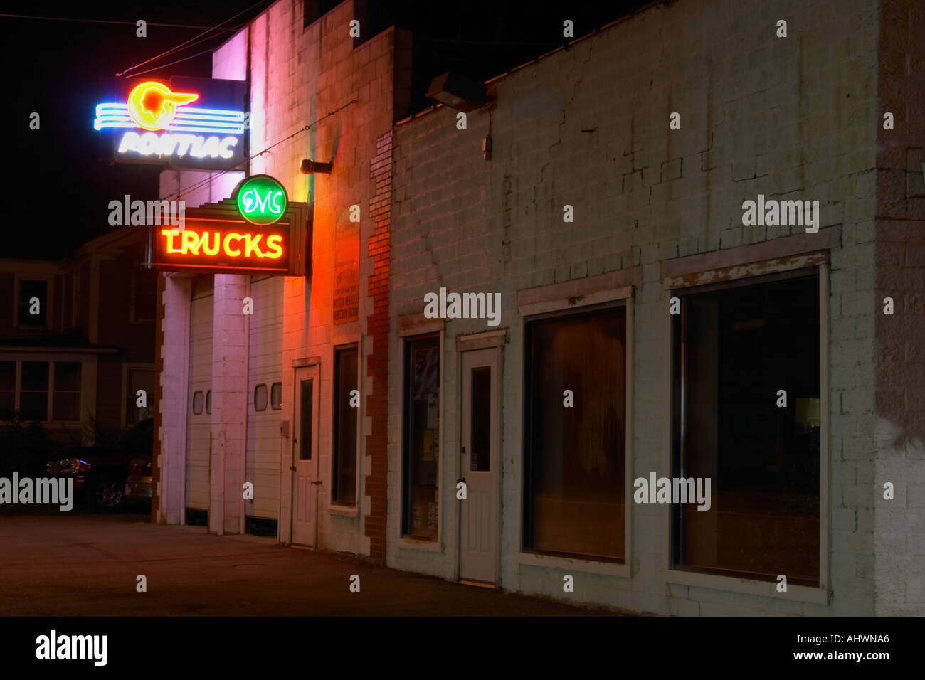 Pontiac and GMC Trucks vintage neon signs at night on an old building ...