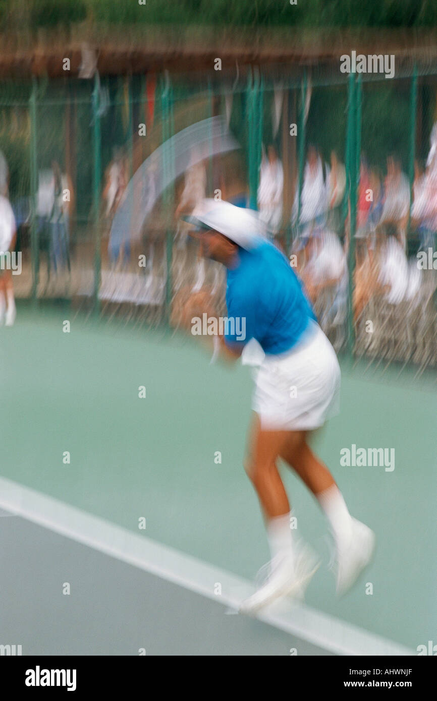 Tennis player swinging racket Stock Photo - Alamy