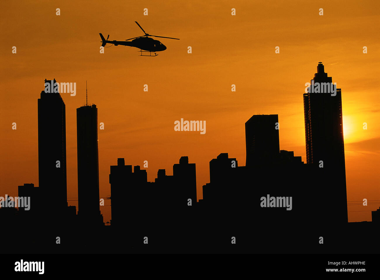 Helicopter flying over Atlanta skyline at sunset Stock Photo - Alamy