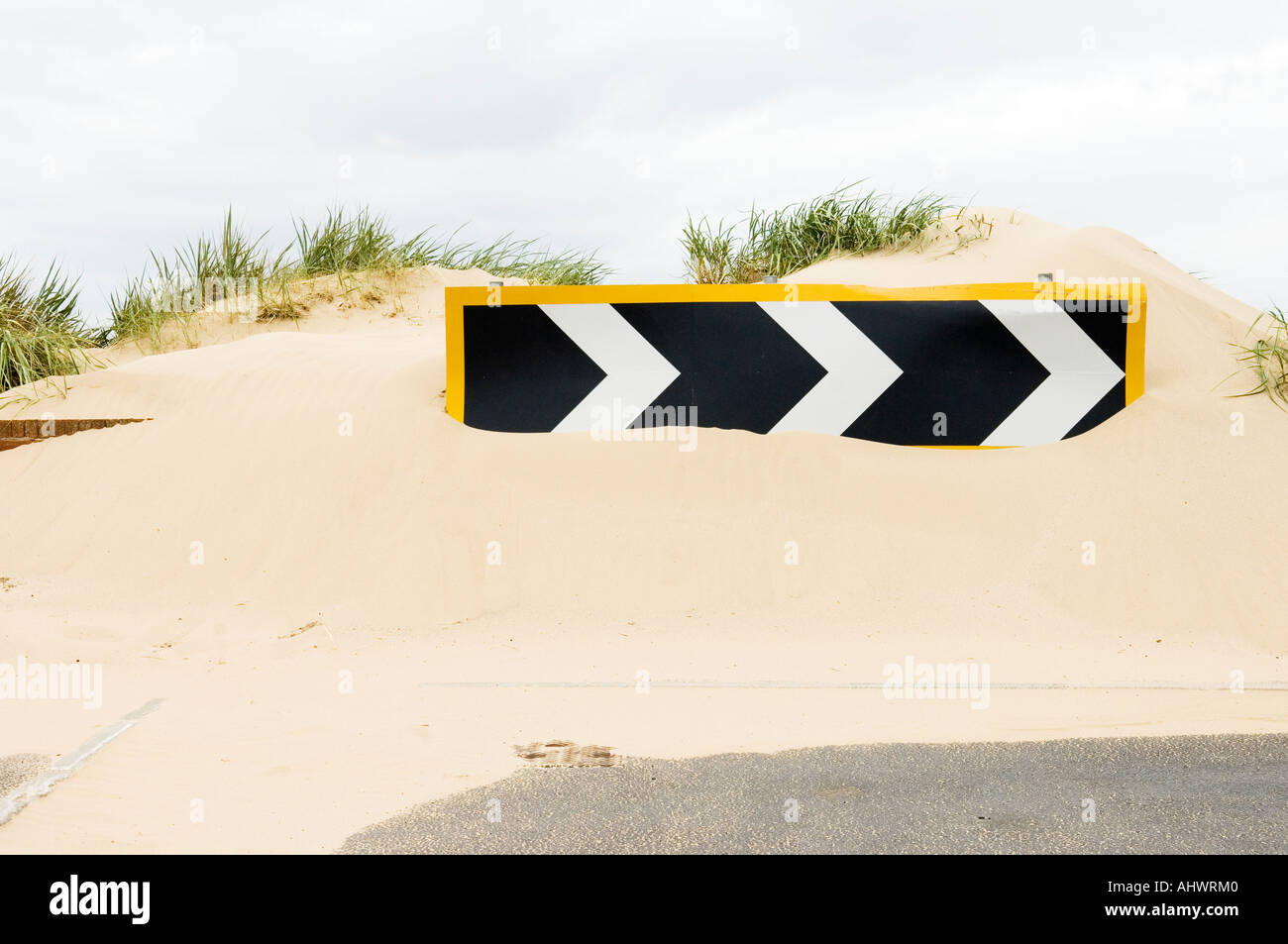 Sand blown from dunes on to road sign Stock Photo - Alamy