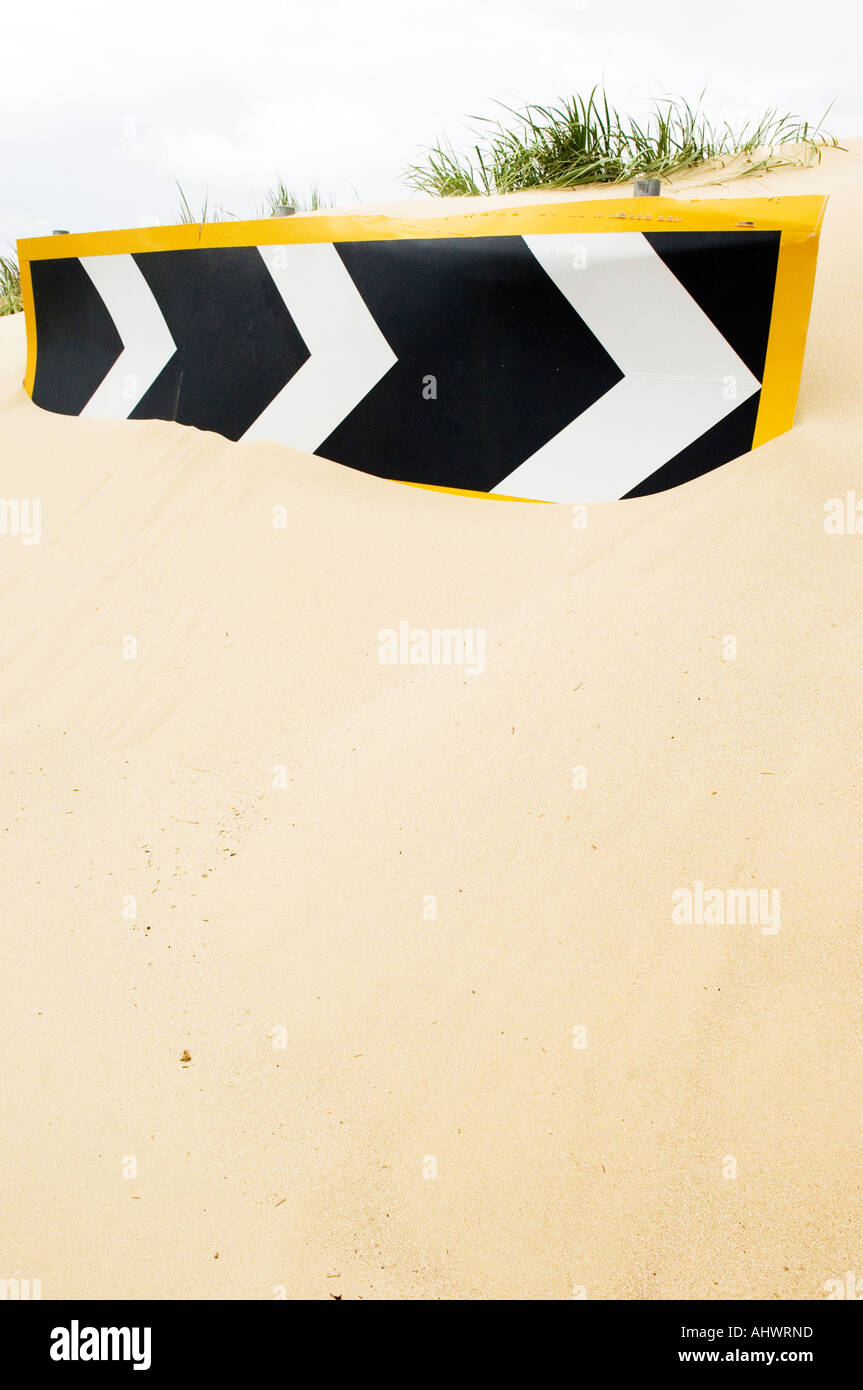 Sand blown from dunes on to road sign Stock Photo - Alamy
