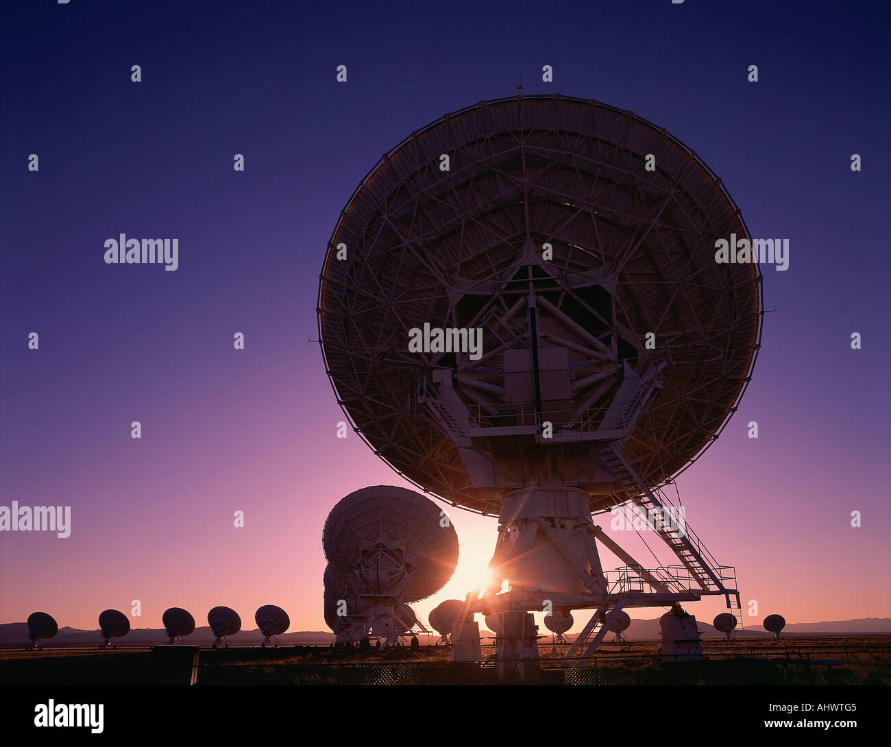 Silhouetted field of VLA Very Large Array radio telescope dishes Stock ...