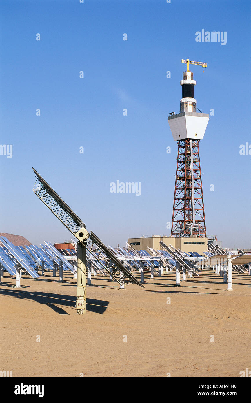 Solar panels at solar energy plant with pylon and building in ...