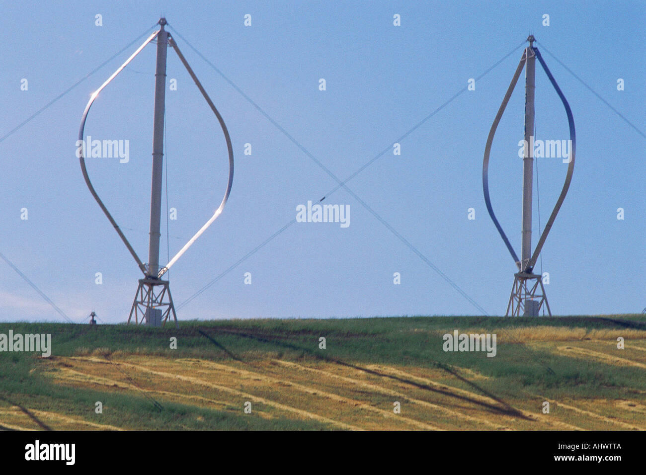 Two vertical axis wind turbines standing on ground Stock Photo - Alamy