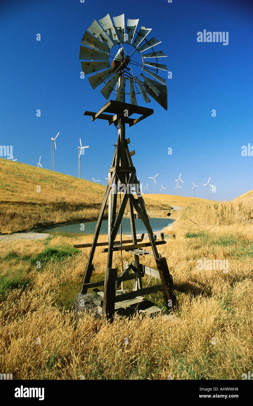 Old windmill with new windmills in background Stock Photo - Alamy