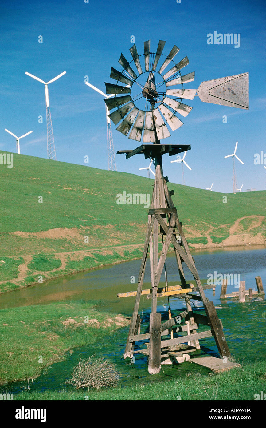 Old windmill with new windmills in background Stock Photo - Alamy