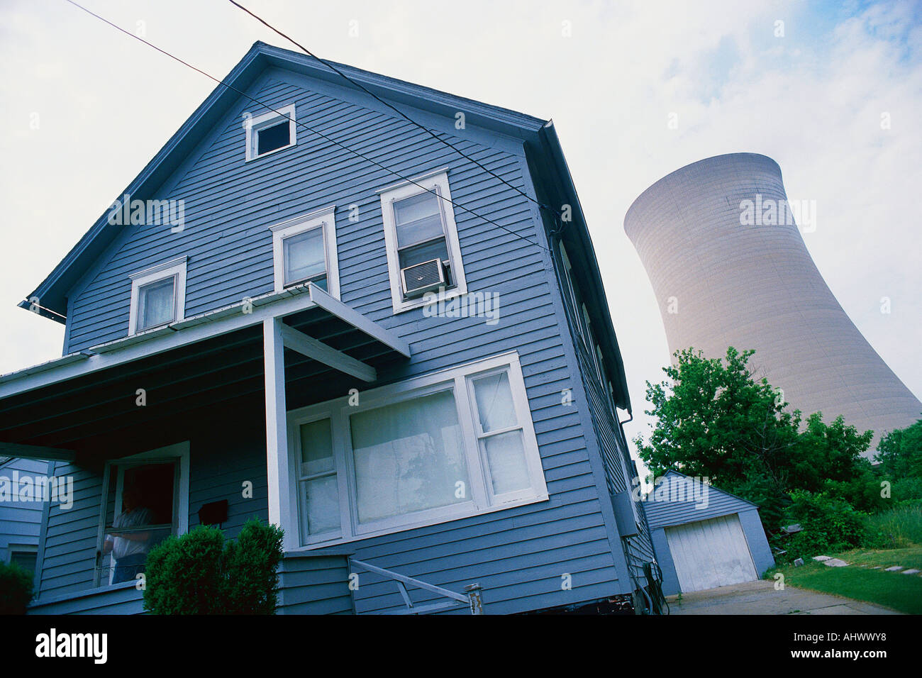House with nuclear cooling tower in background Stock Photo - Alamy