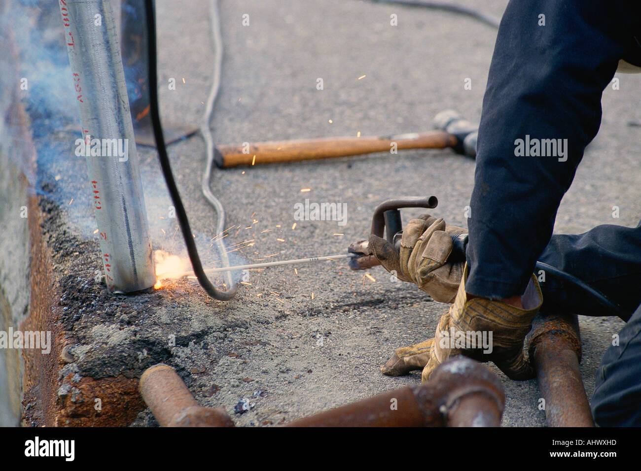 Worker welding steel pole Stock Photo - Alamy