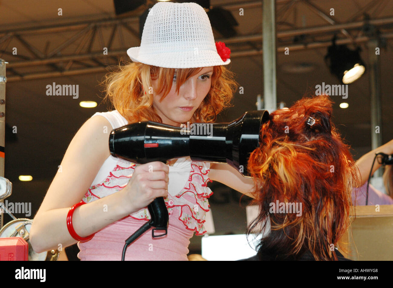 Young lady hairdresser at work at annual hair fashion contest Limburg ...