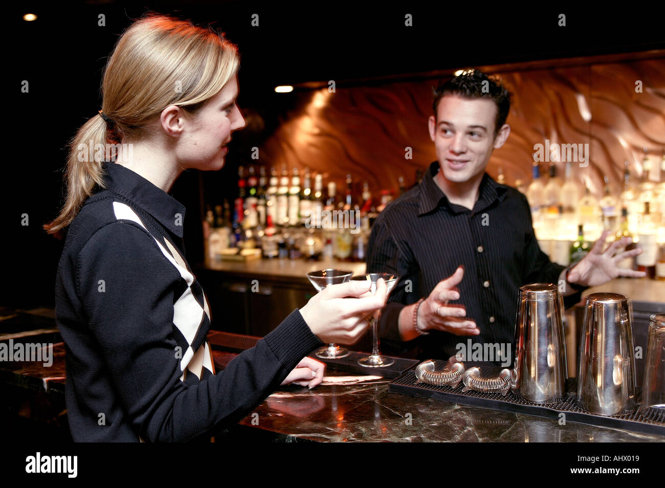 Bartender talking to customers Stock Photo - Alamy