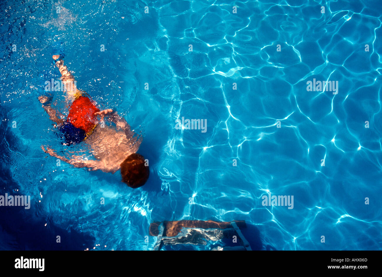 Boy in swimming pool Photo by Ron Medvescek Stock Photo - Alamy