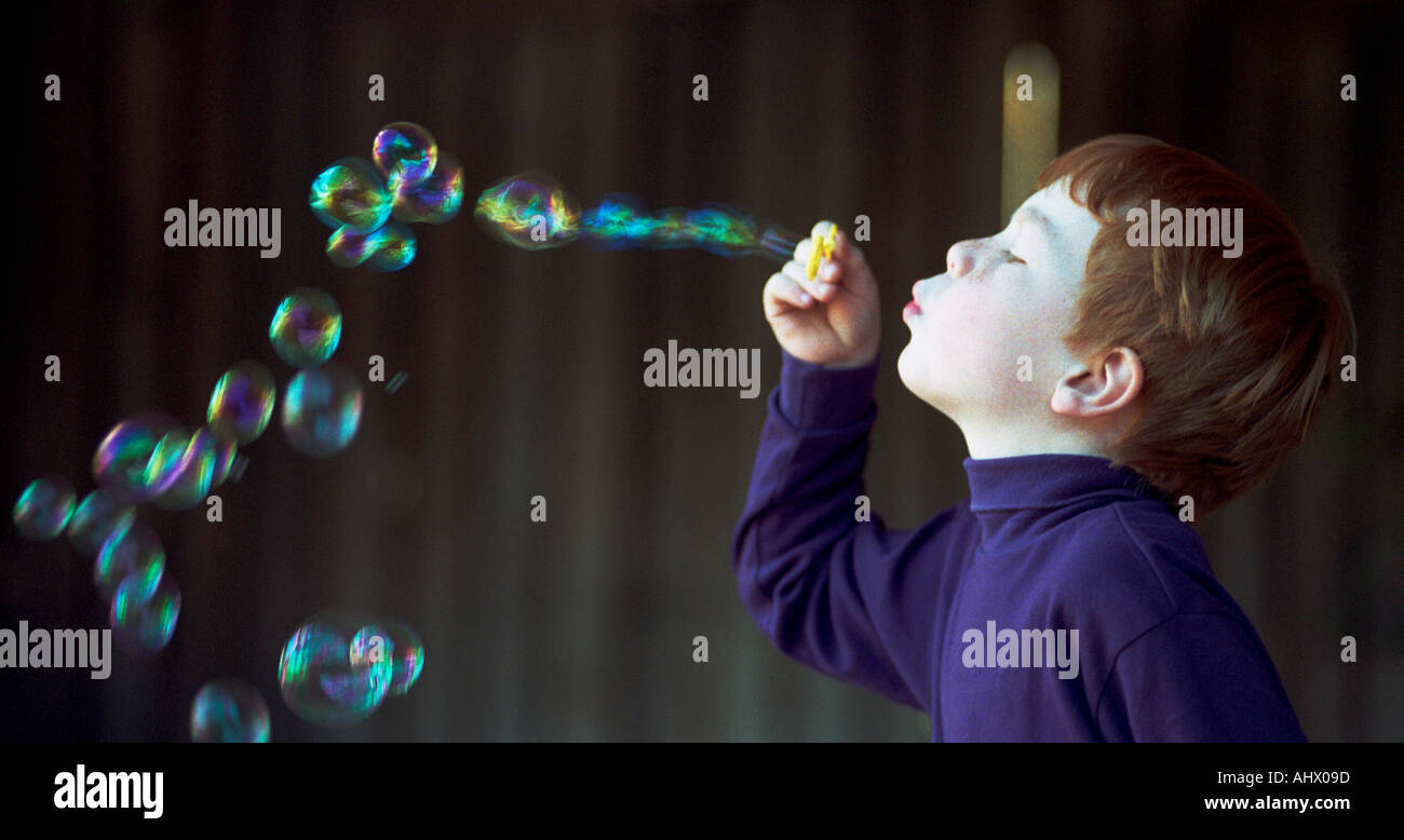Boy blowing bubble stream Stock Photo - Alamy