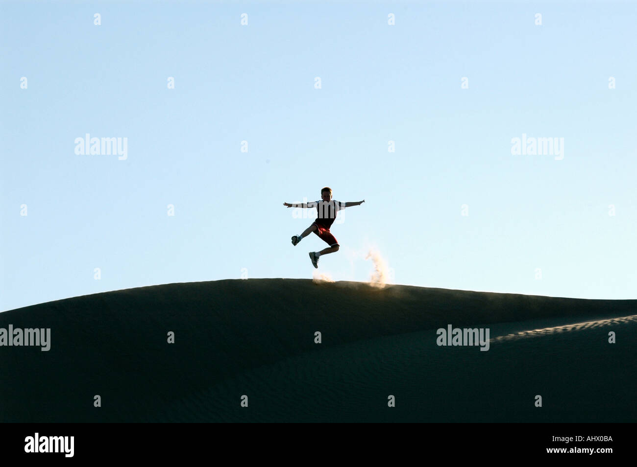 Boy jumping on a dune at Imperial Sand Dunes California Stock Photo - Alamy