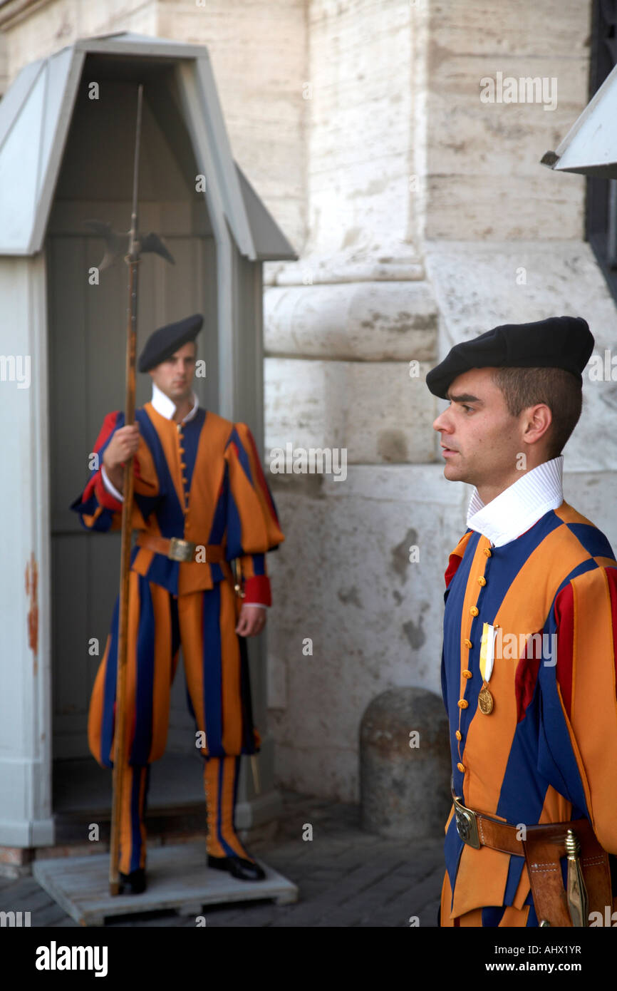 Two Papal Swiss Guards stand guard in traditional uniform with pike in ...