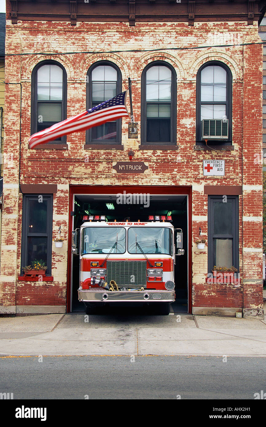 Fire engine parked in firehouse Stock Photo - Alamy