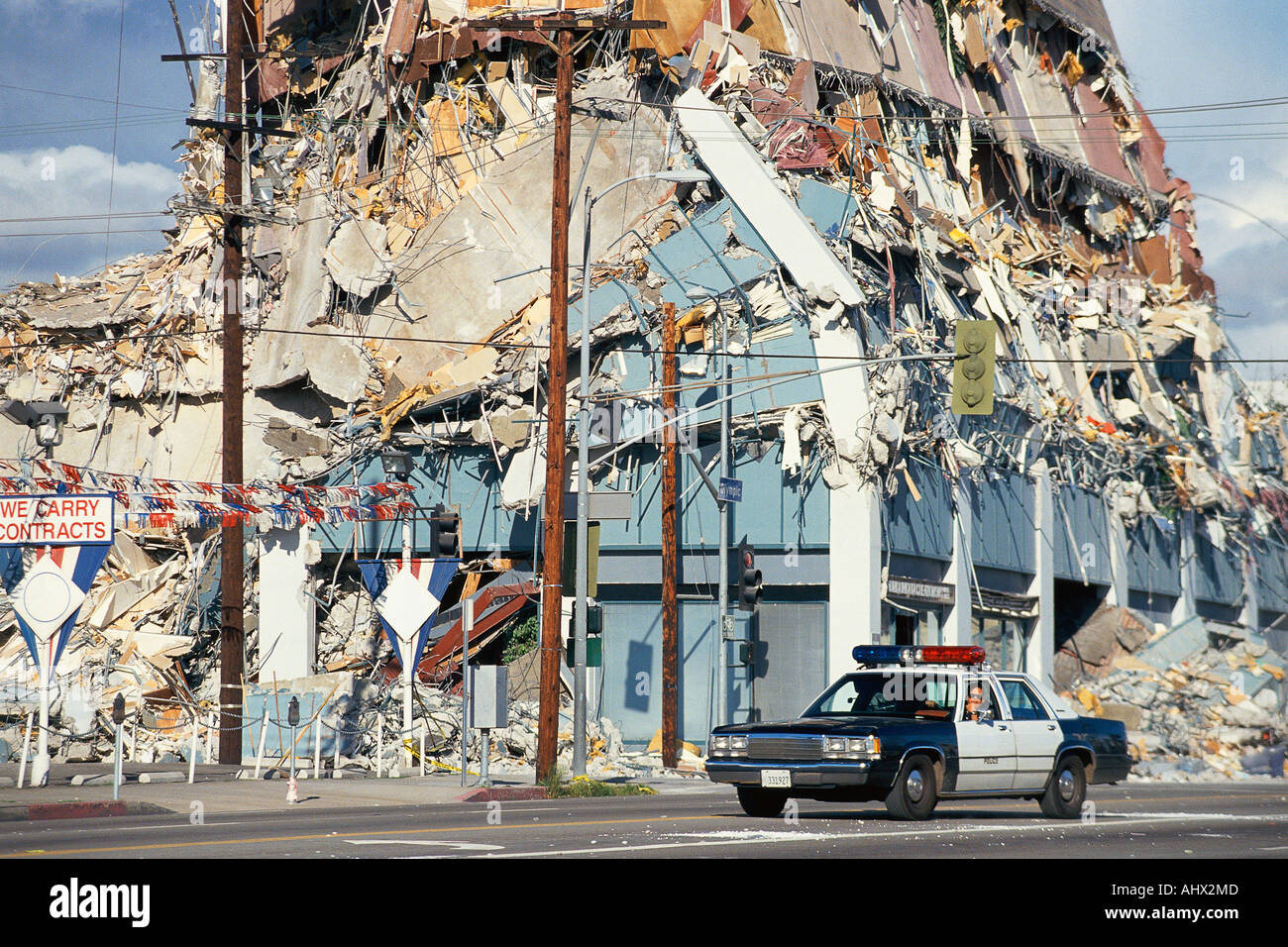 Collapsed building with police car on patrol Stock Photo - Alamy