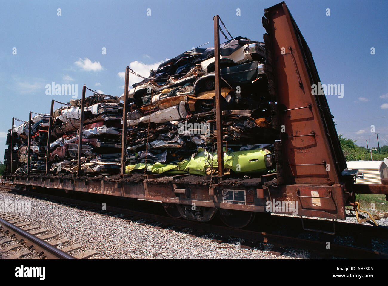 Junked smashed cars on railroad car Stock Photo - Alamy