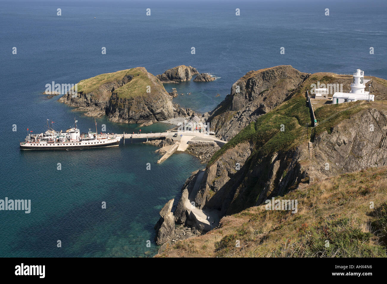 England. Lundy island. Boat landing stage and lighthouse Stock Photo ...